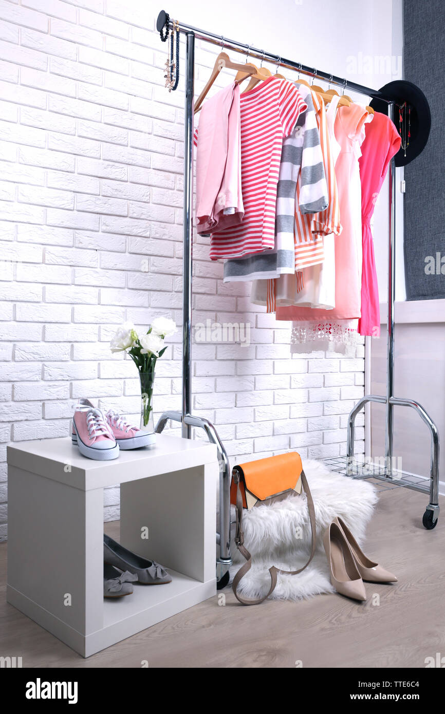 Collection of female clothes hanging on a rack Stock Photo - Alamy