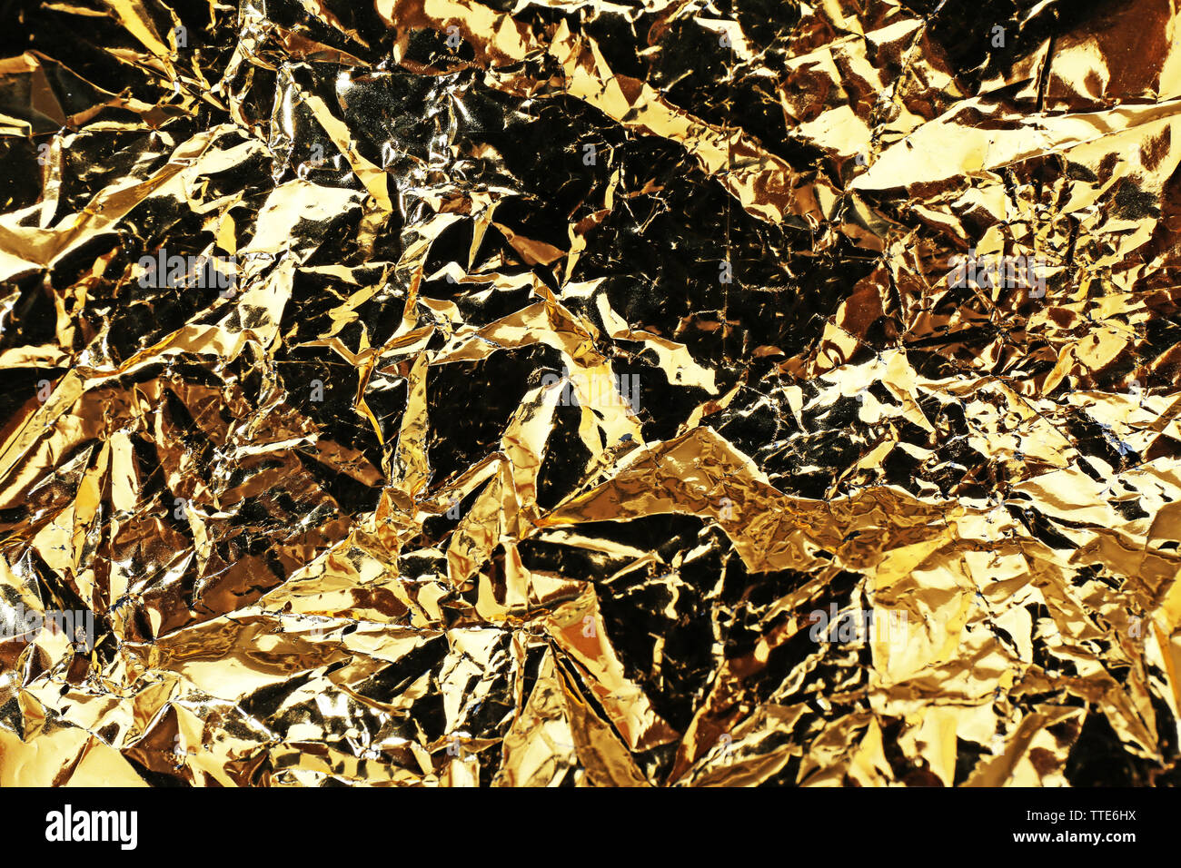 Bronze crumpled foil background Stock Photo - Alamy