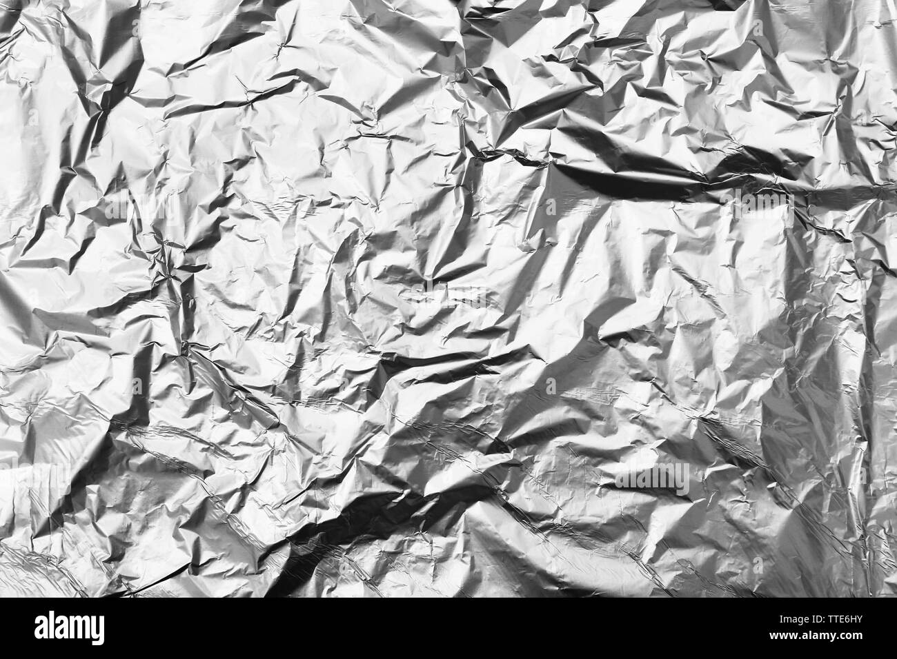 Silver crumpled foil background Stock Photo - Alamy