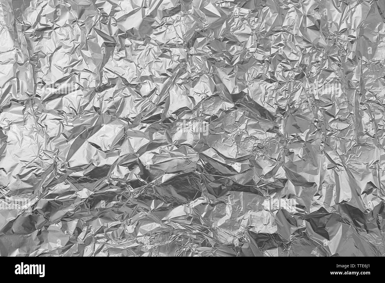 Silver crumpled foil background Stock Photo - Alamy