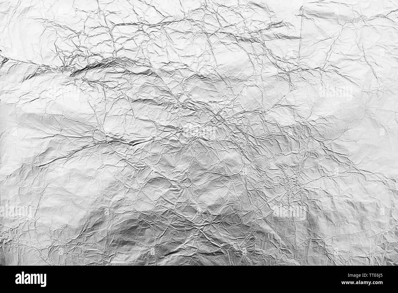Silver crumpled foil background Stock Photo - Alamy