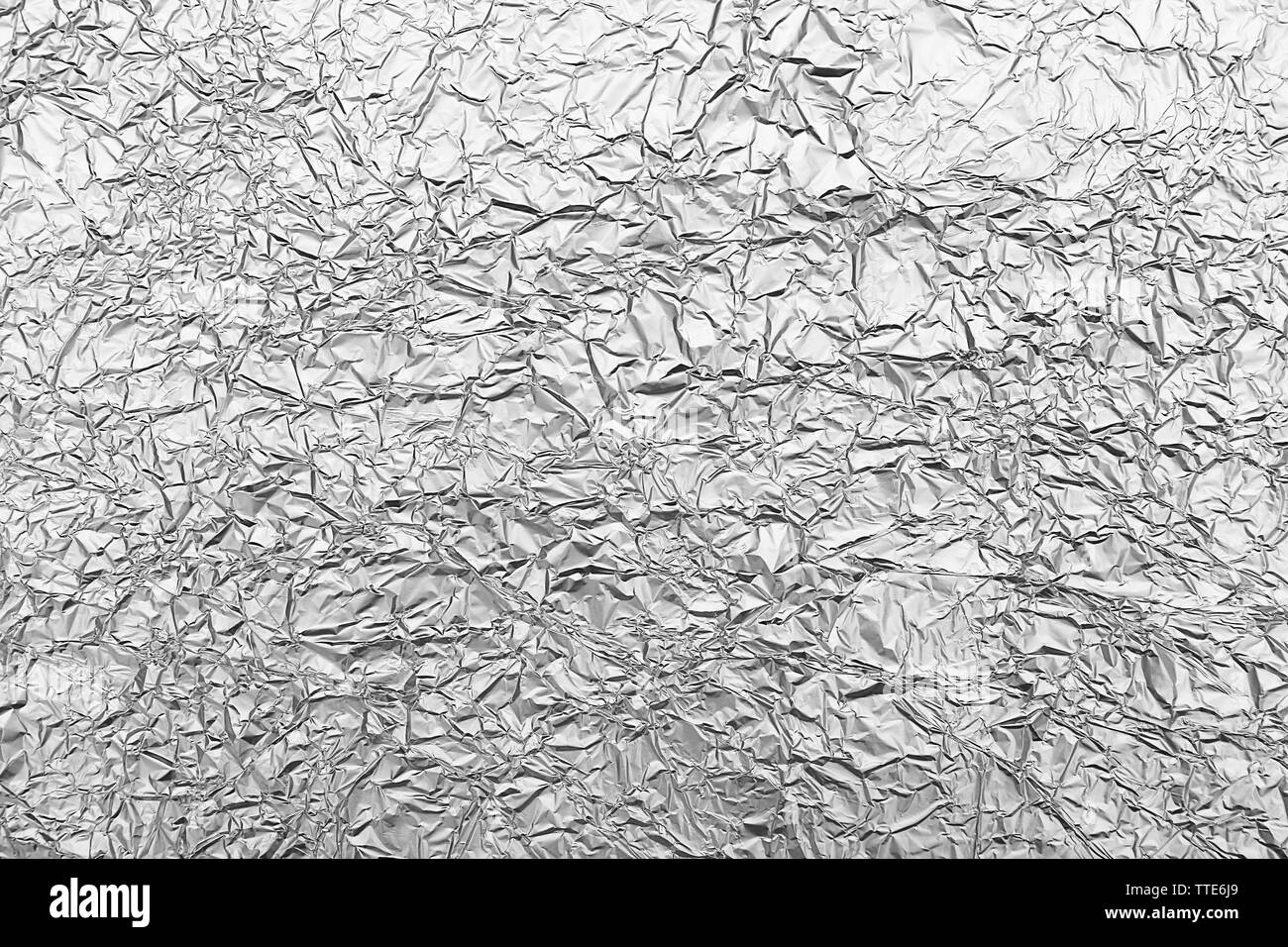 Silver crumpled foil background Stock Photo - Alamy