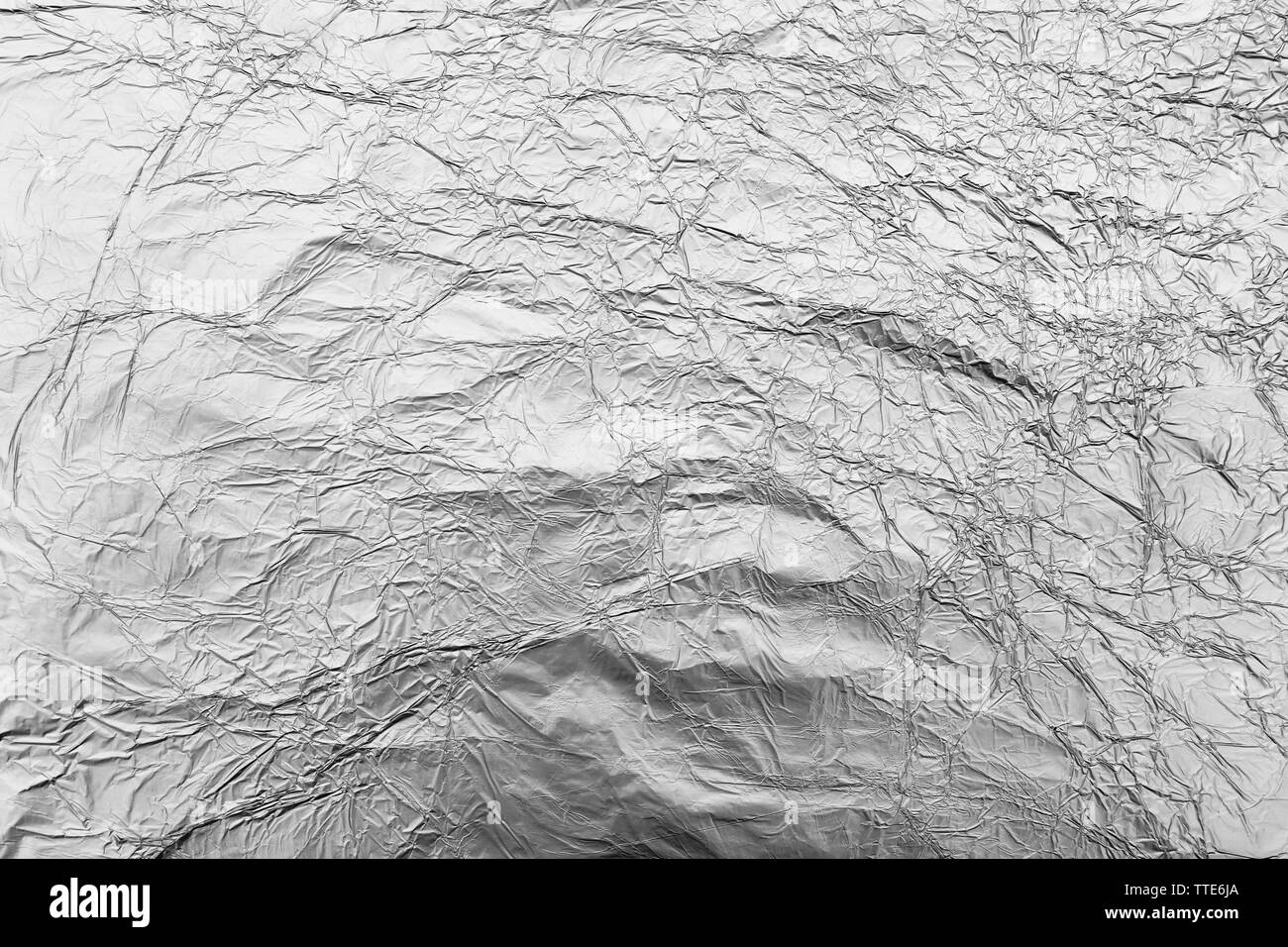 Silver crumpled foil background Stock Photo - Alamy