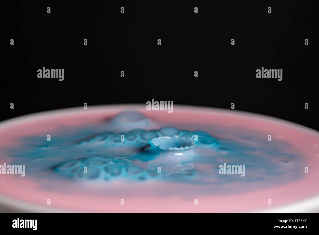 Splash of milk droplets in close up macro high resolution isolated ...