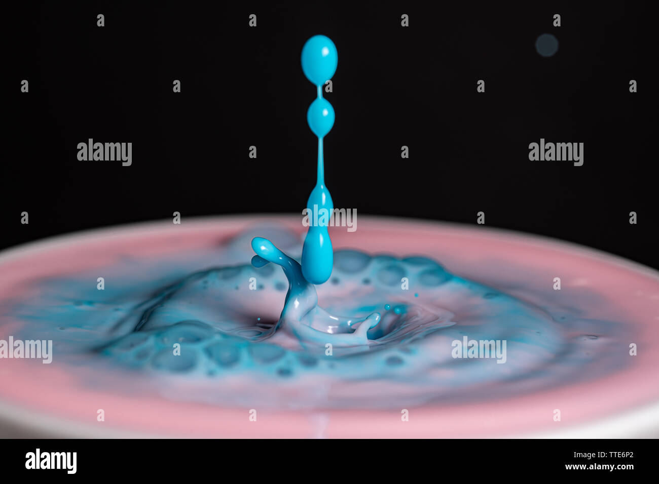 Splash of milk droplets in close up macro high resolution isolated ...
