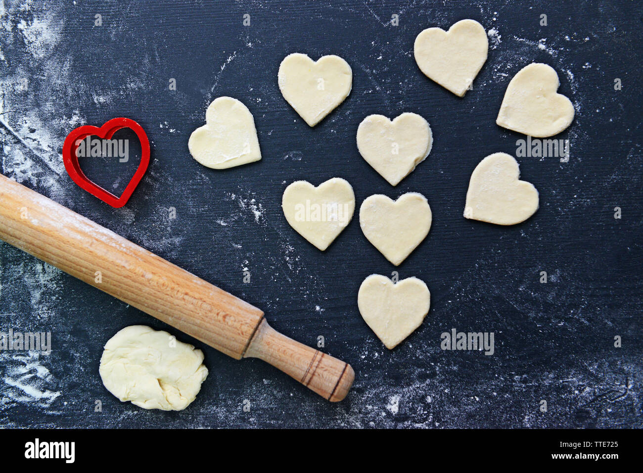 Uncooked heart shaped biscuits on a table Stock Photo - Alamy