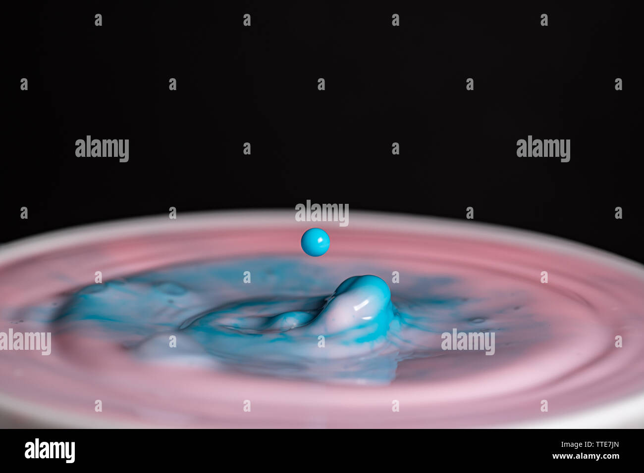 Splash of milk droplets in close up macro high resolution isolated ...