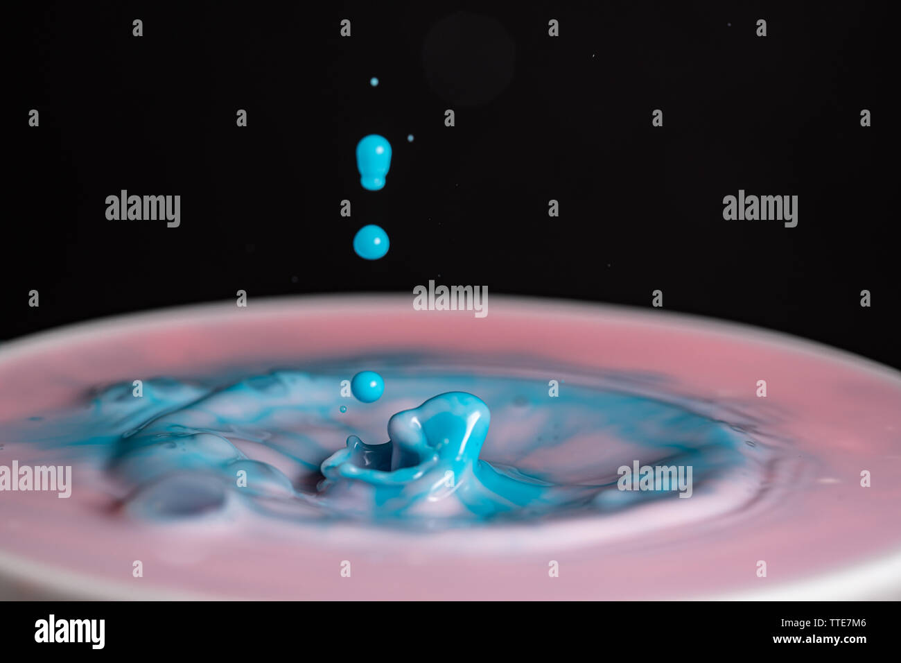 Splash of milk droplets in close up macro high resolution isolated ...