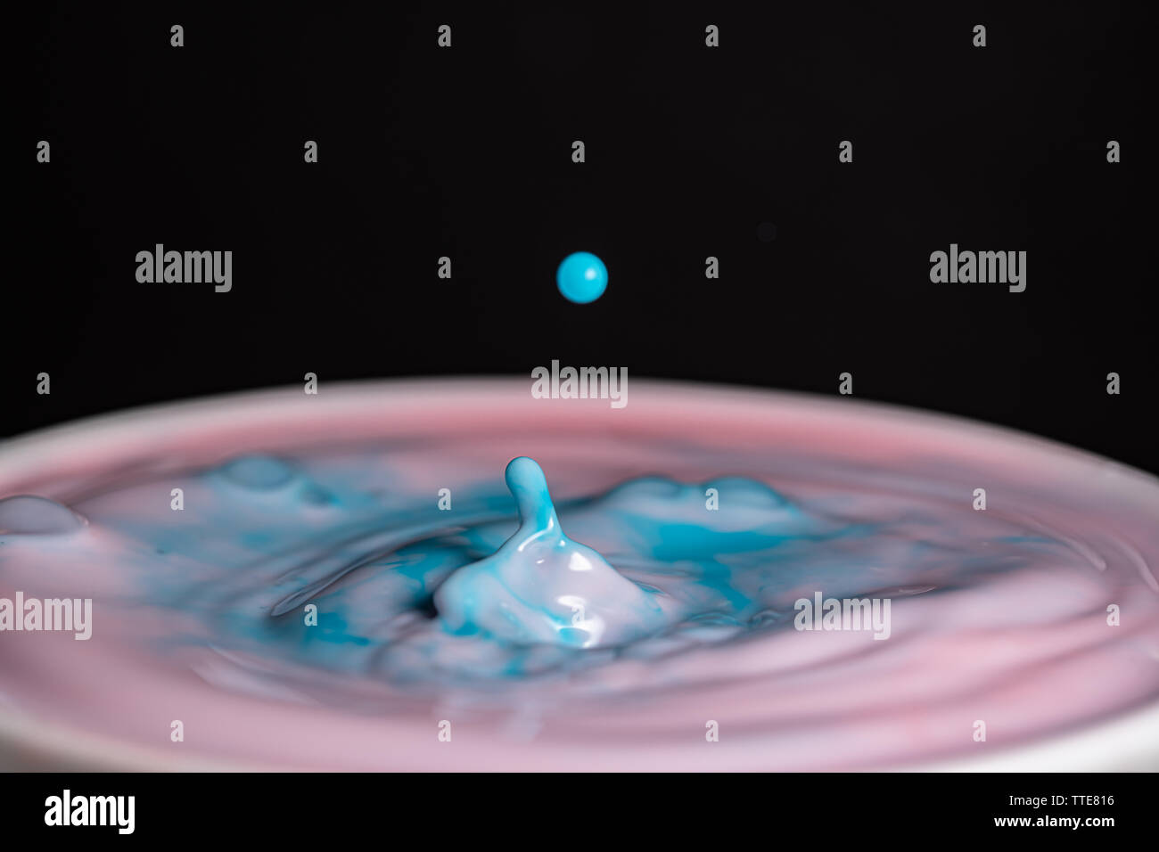 Splash of milk droplets in close up macro high resolution isolated ...