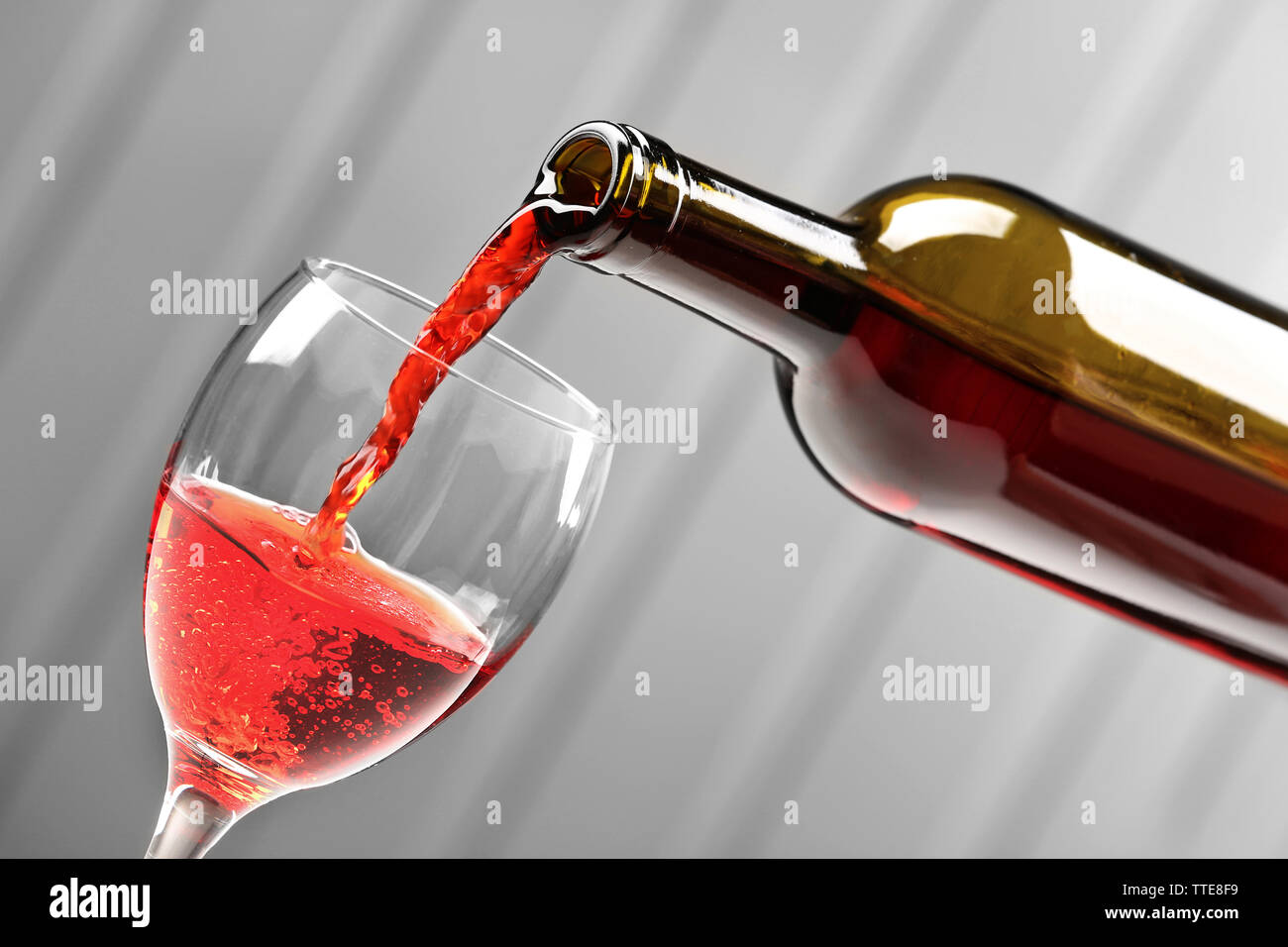 Pouring wine on wall background Stock Photo - Alamy
