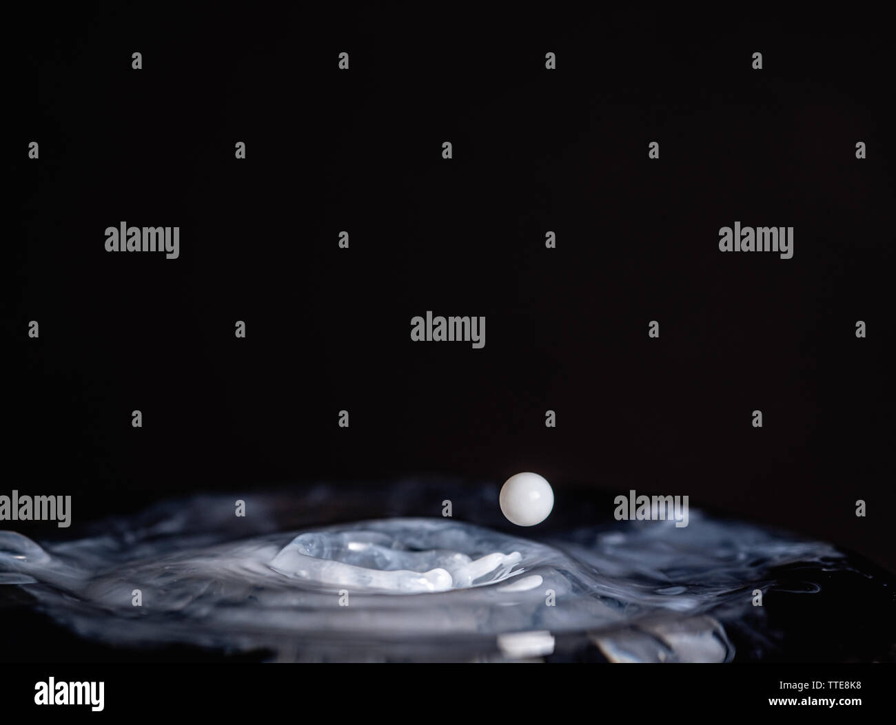 Splash of milk droplets in close up macro high resolution isolated ...