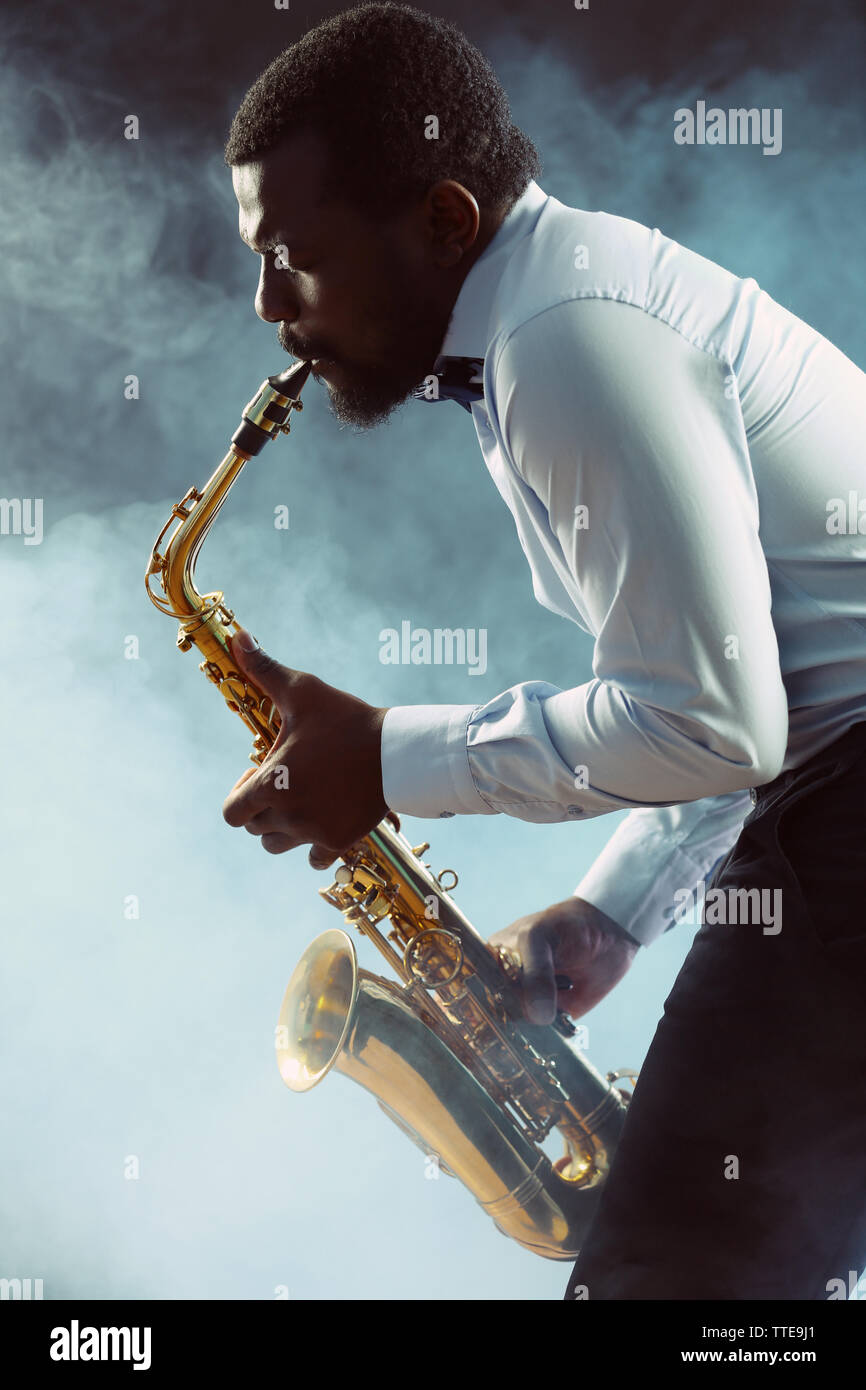 African American jazz musician playing the saxophone against colorful ...