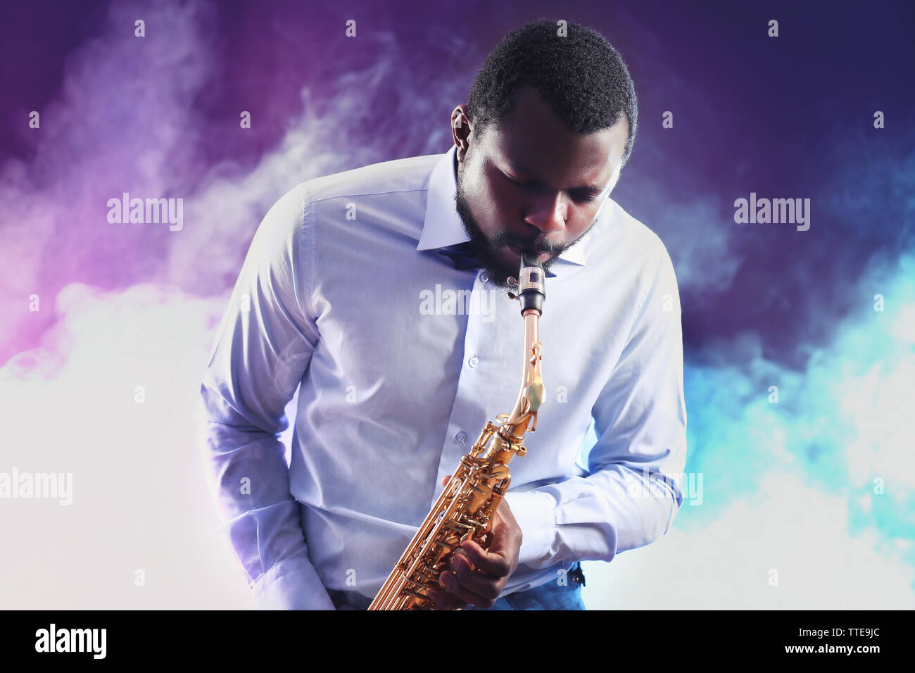 African American jazz musician playing the saxophone against colorful ...