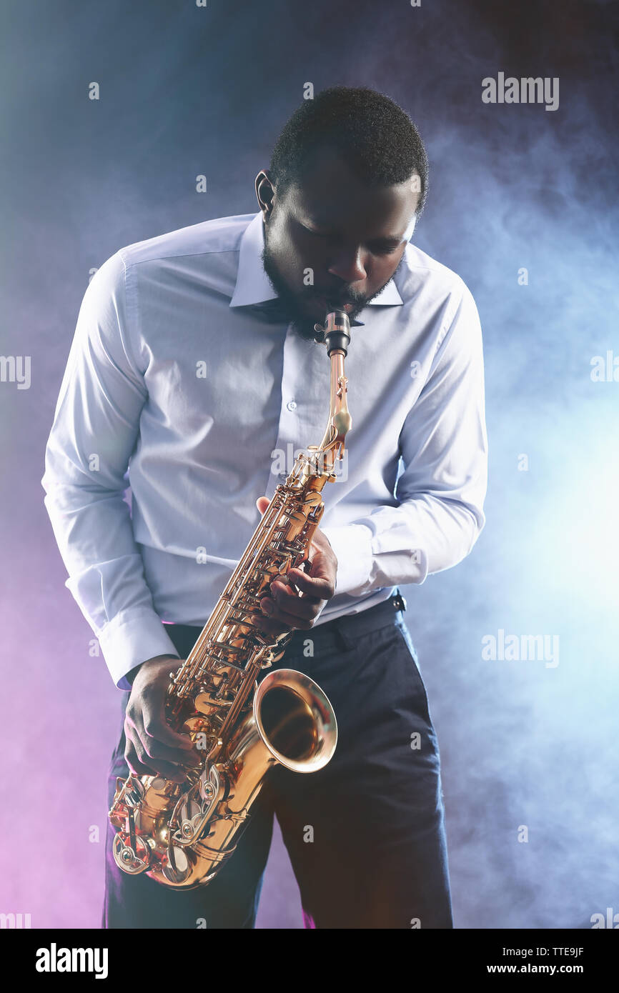 African American jazz musician playing the saxophone against colorful ...