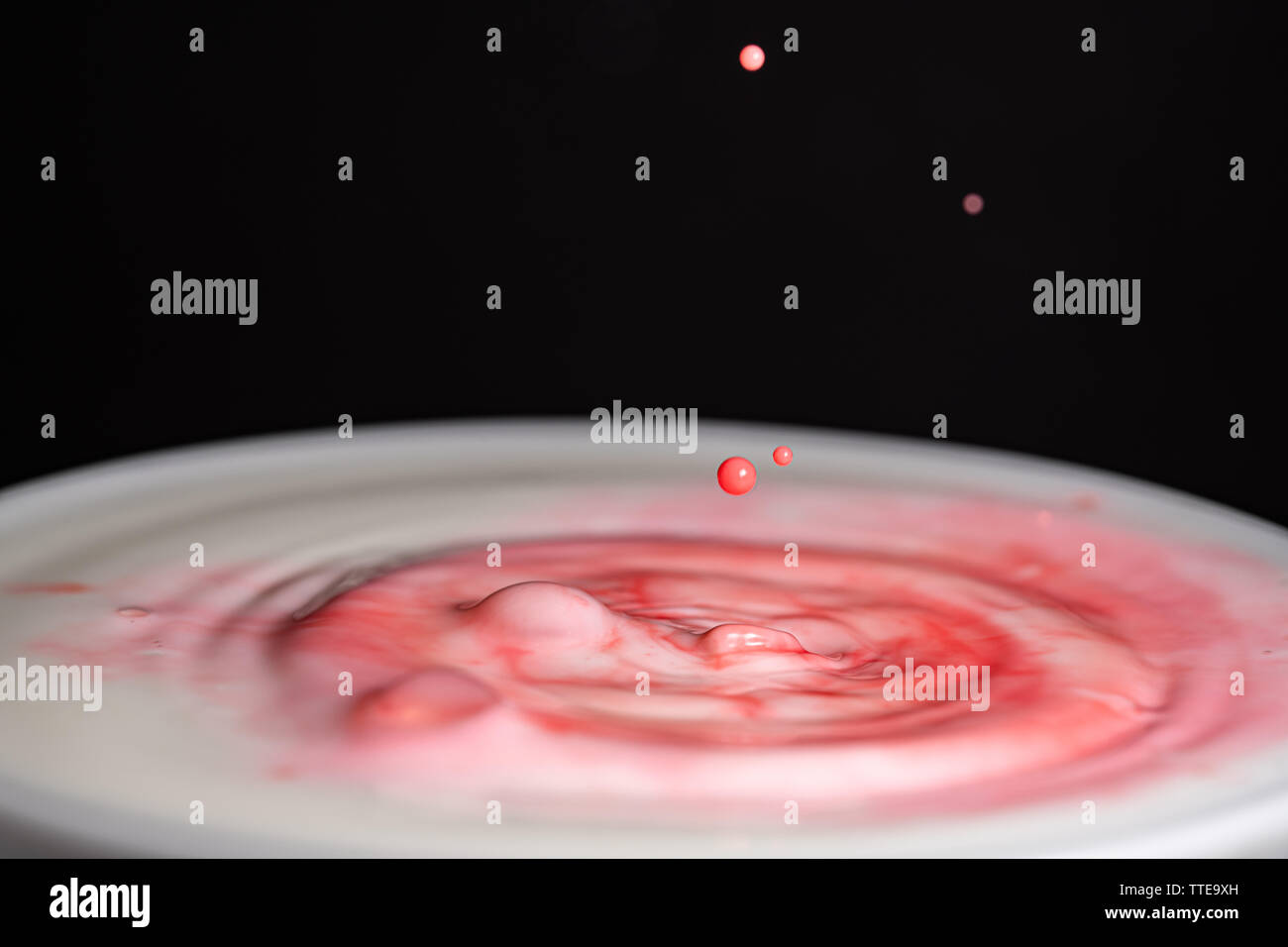 Splash of milk droplets in close up macro high resolution isolated ...