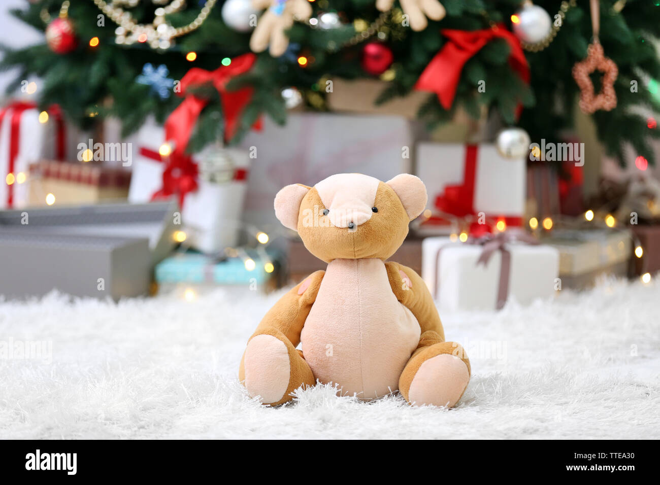 Christmas tree with teddy bear and gift boxes Stock Photo - Alamy
