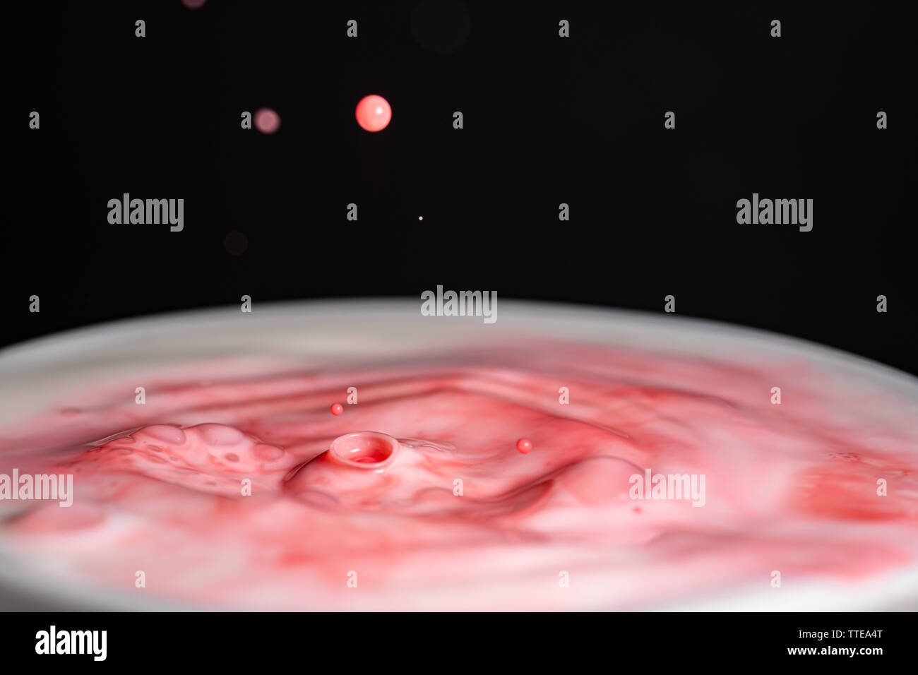 Splash of milk droplets in close up macro high resolution isolated ...