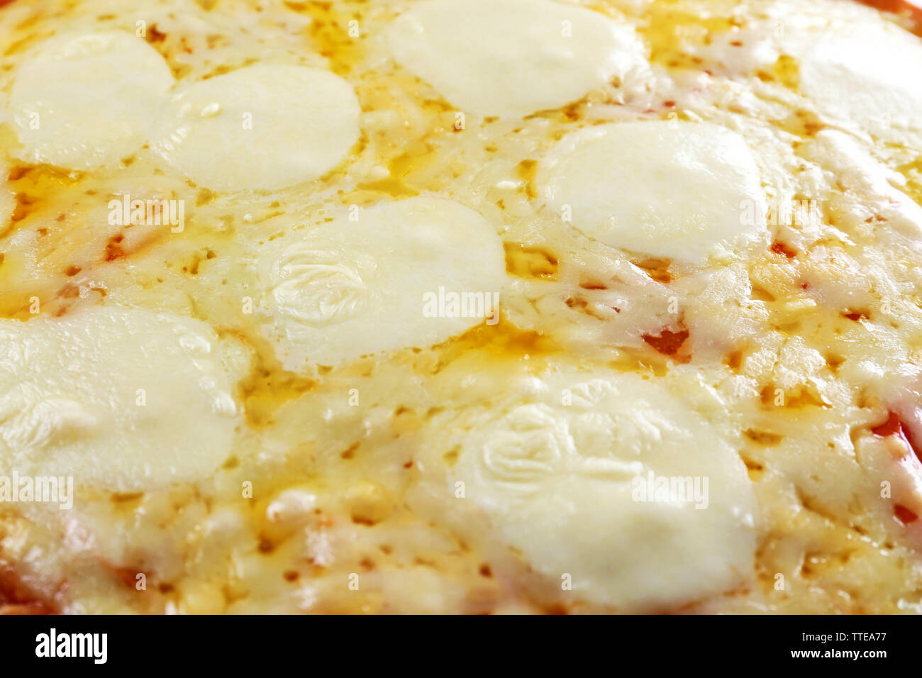Pizza full of cheese background Stock Photo - Alamy