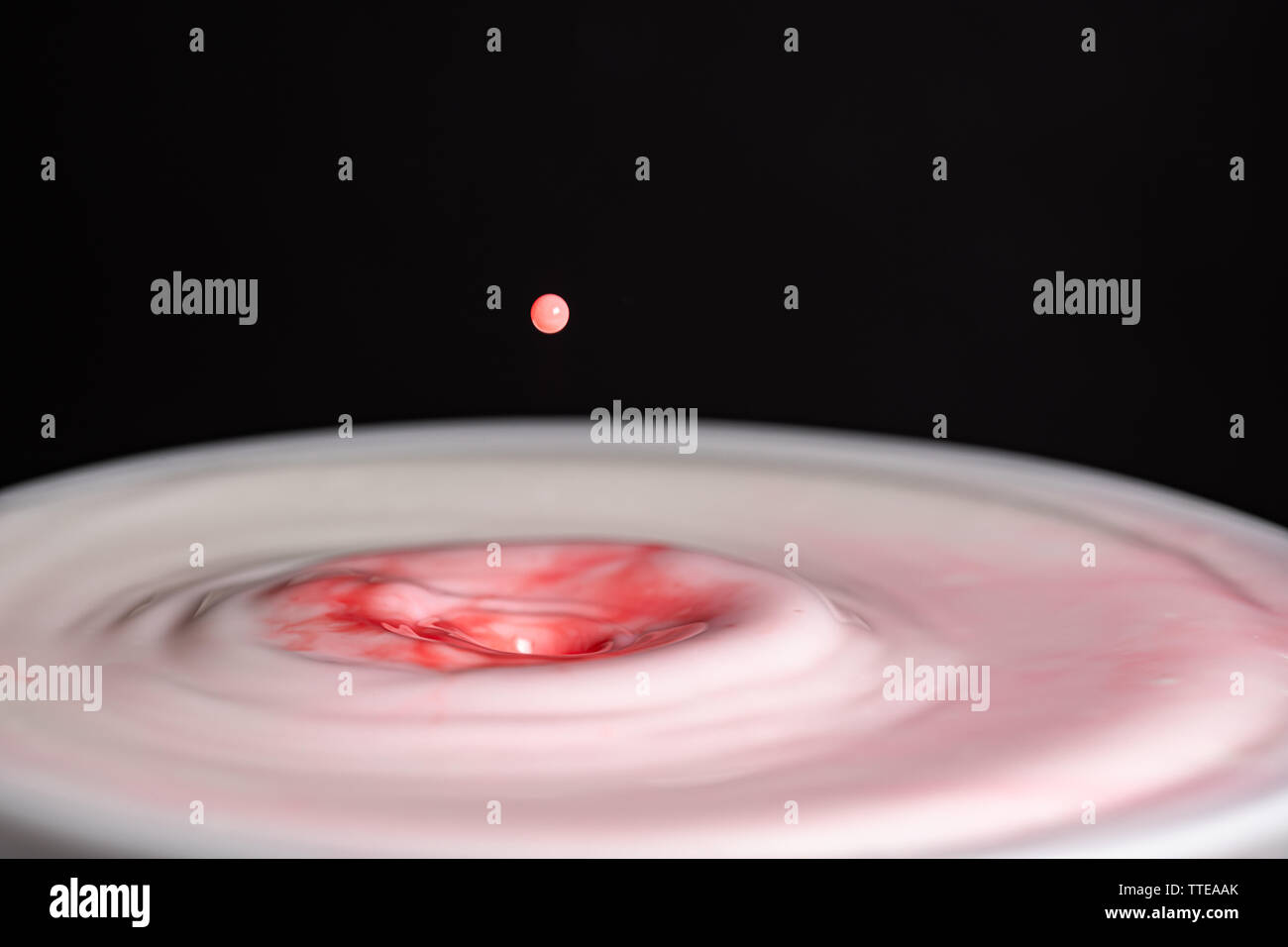 Splash of milk droplets in close up macro high resolution isolated ...