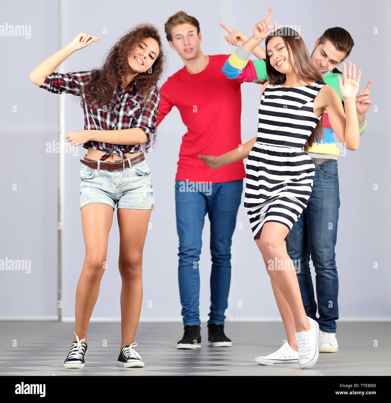 Teenager friends dancing together Stock Photo - Alamy