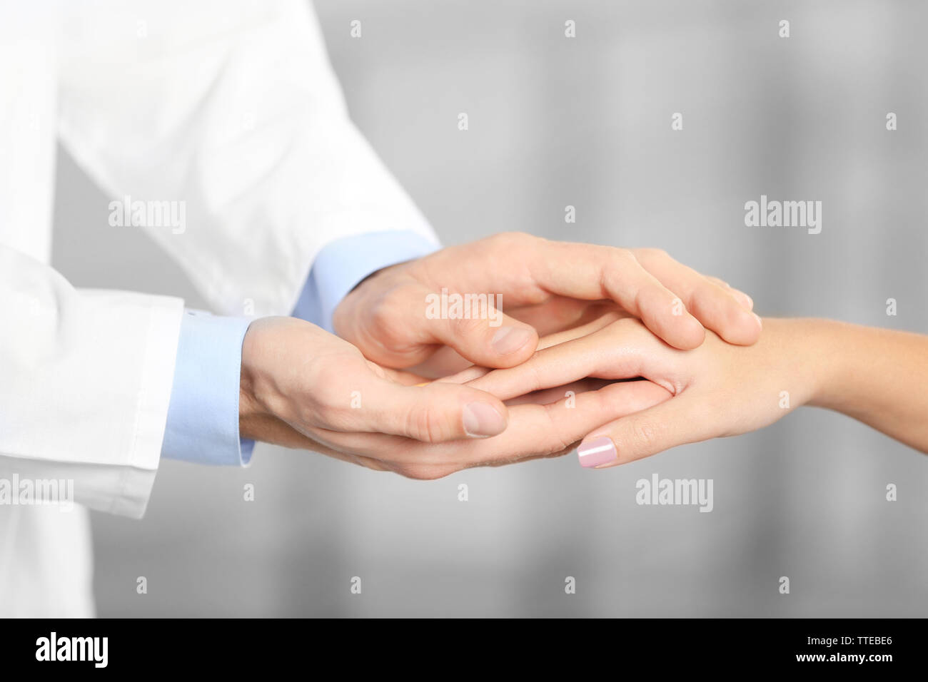 Hand of medical doctor carefully holding patient's hands Stock Photo ...