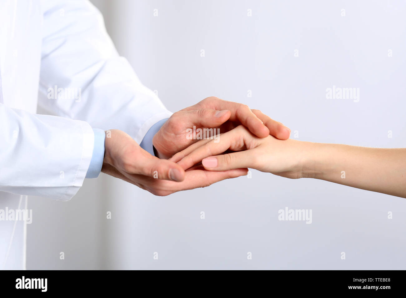 Hand of medical doctor carefully holding patient's hands Stock Photo ...