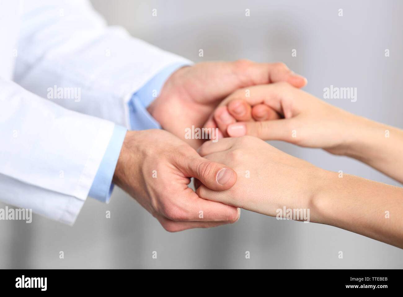 Hand of medical doctor carefully holding patient's hands Stock Photo ...