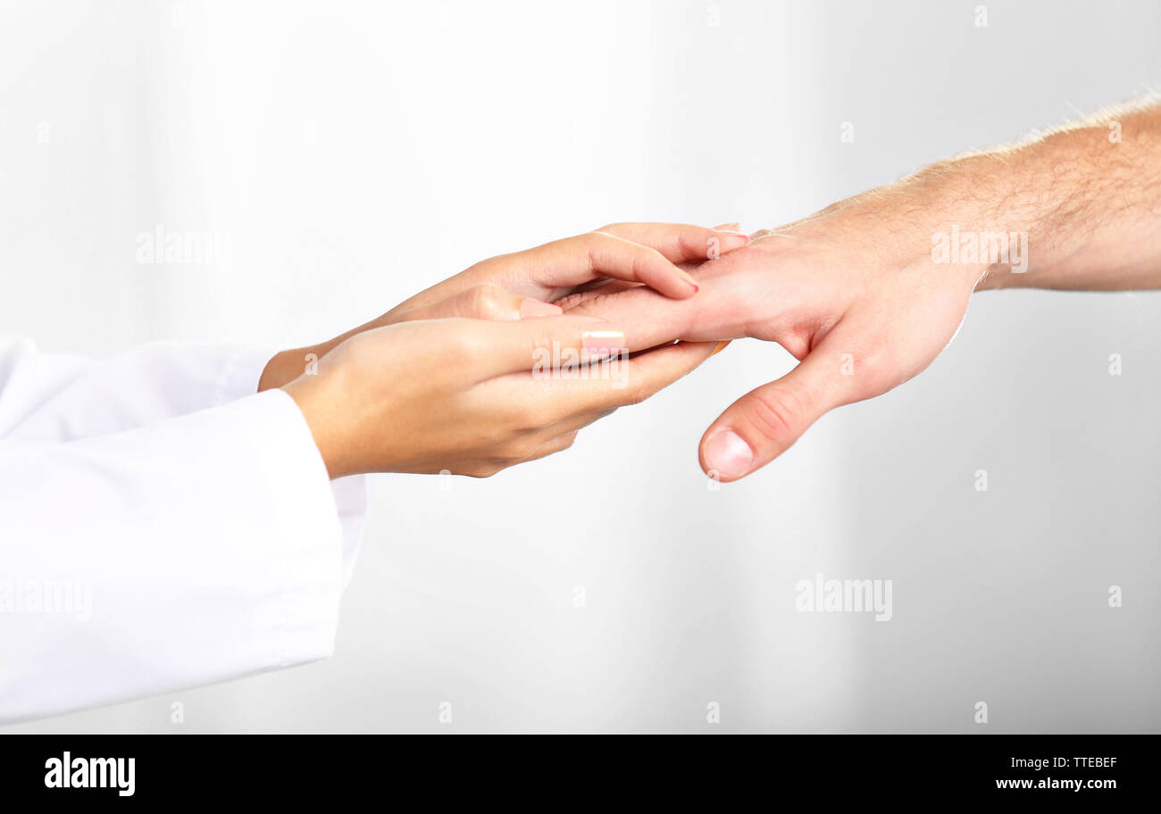 Hand of medical doctor carefully holding patient's hands Stock Photo ...