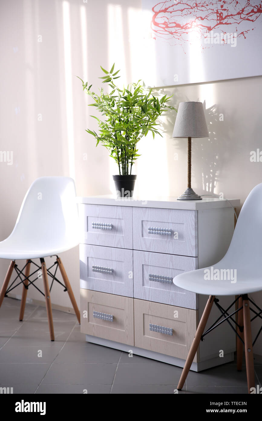 Modern chest with green plant in the room Stock Photo - Alamy