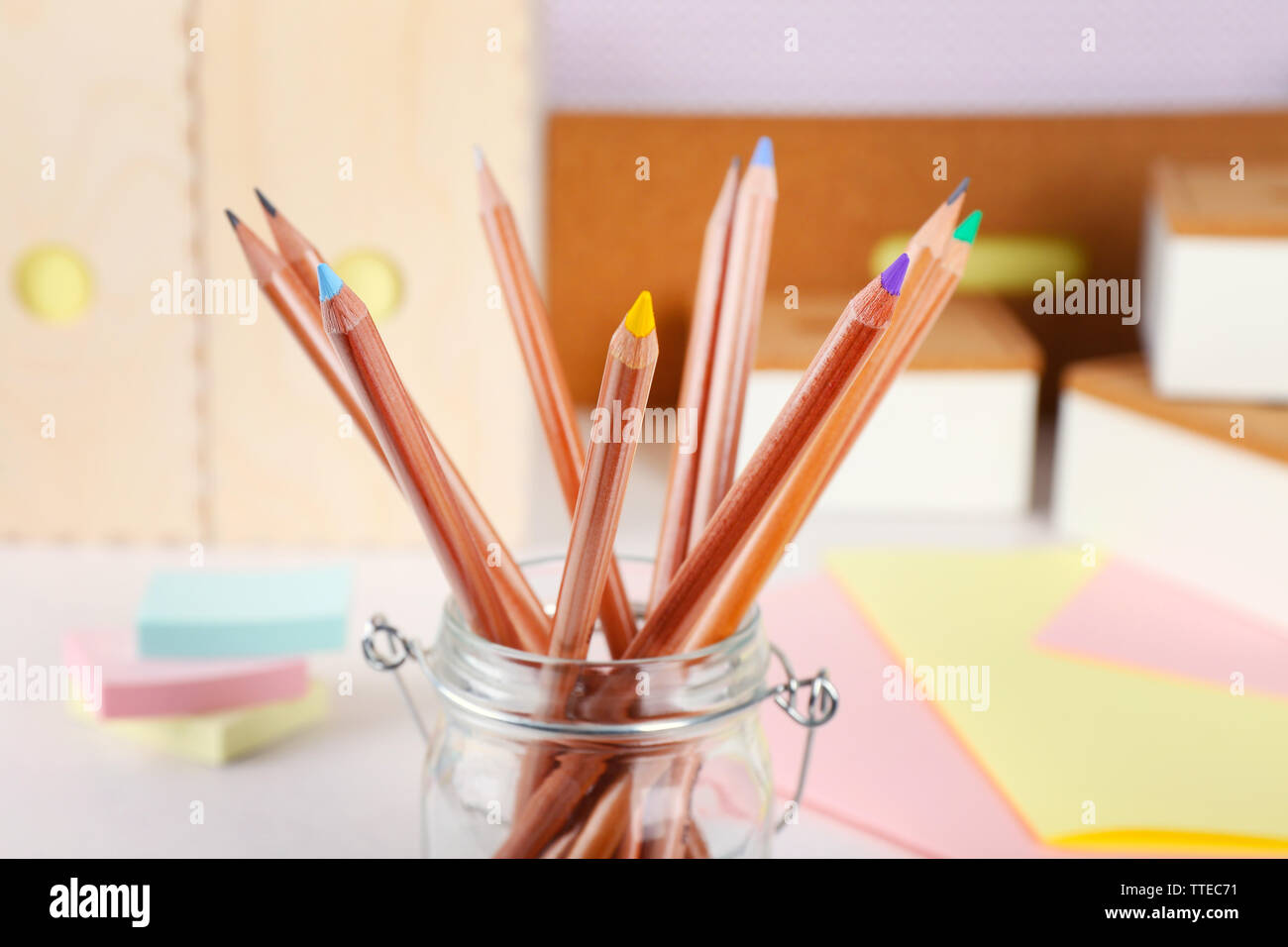 Set of coloured pencils in a glass pot, close up Stock Photo - Alamy