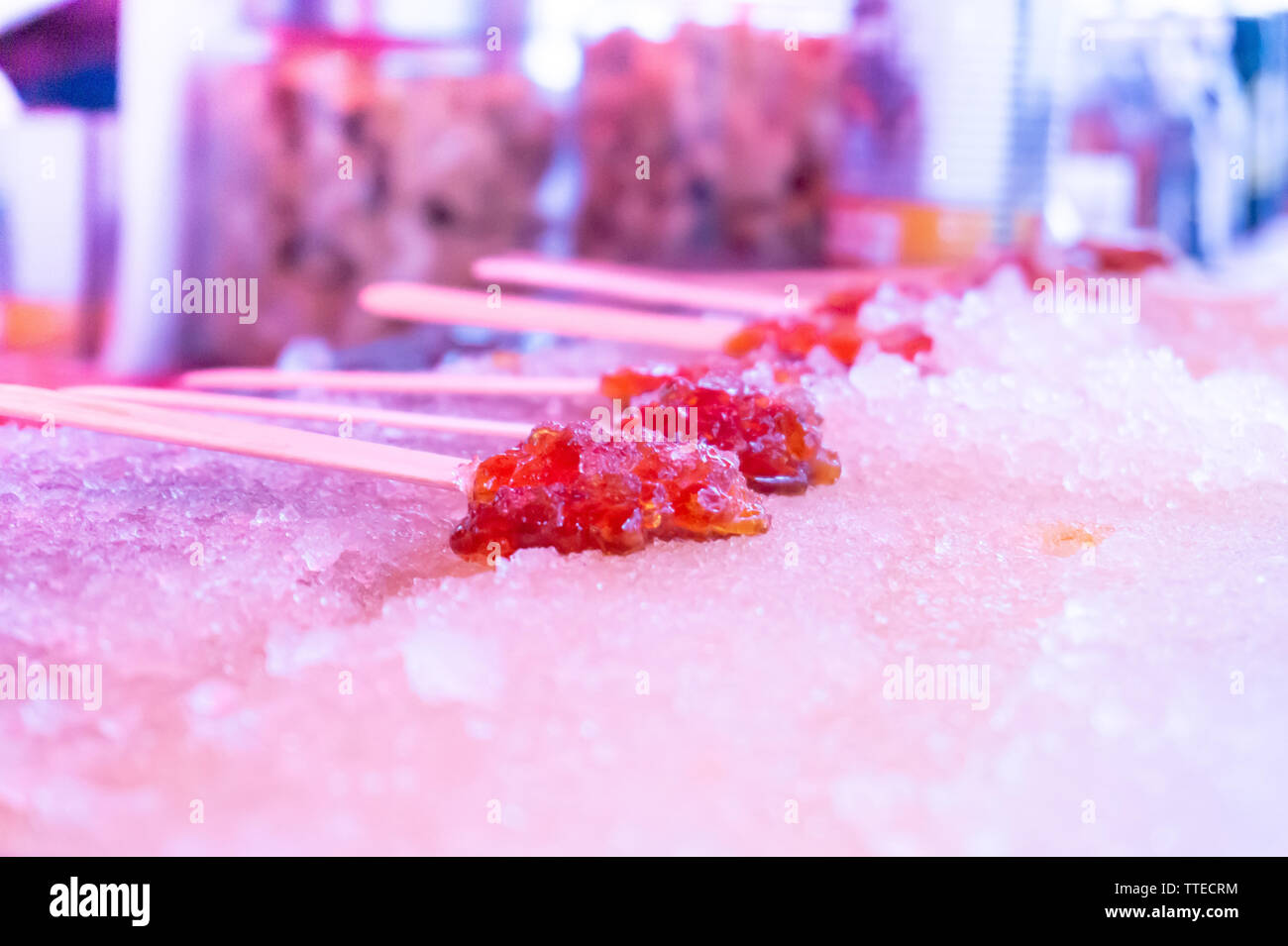 Maple snow candy sticks (maple toffee) sitting on ice, after being ...