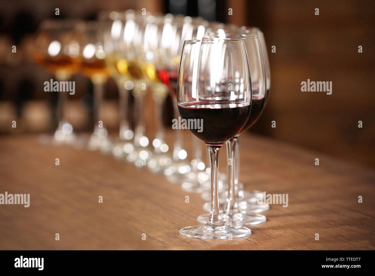 Many glasses of different wine in a row on bar counter Stock Photo - Alamy