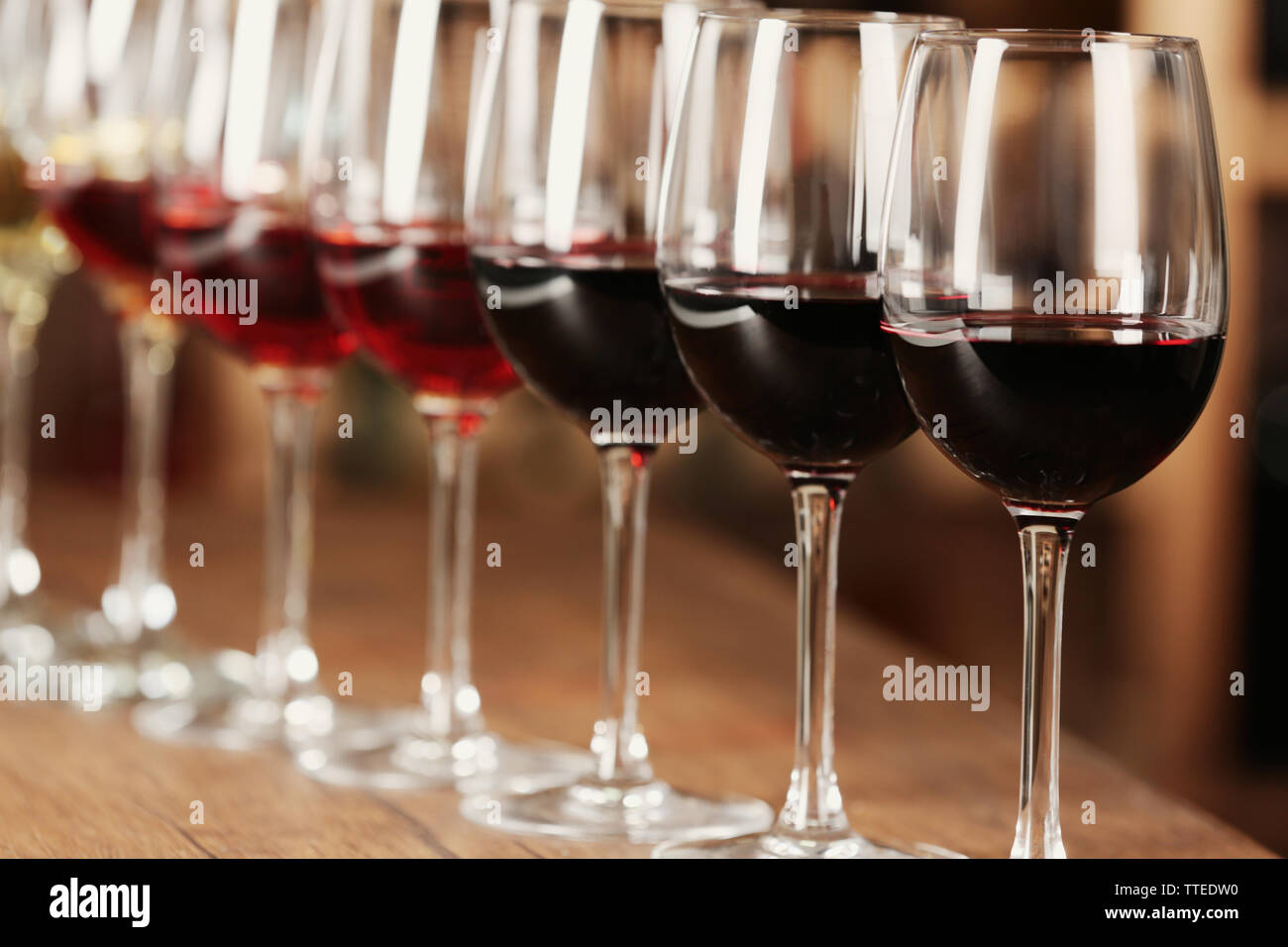 Many glasses of different wine in a row on bar counter Stock Photo - Alamy