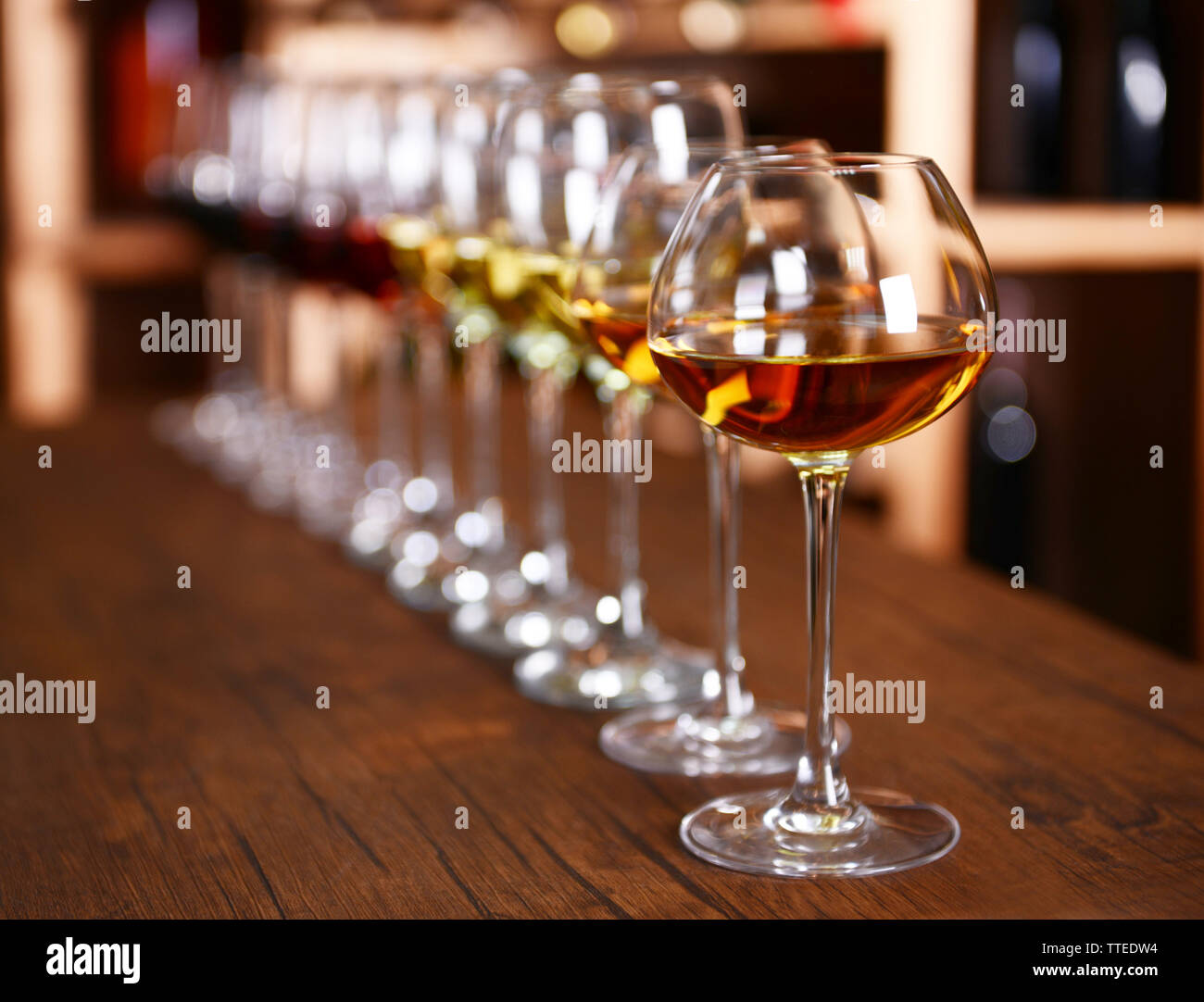 Many glasses of different wine in a row on bar counter Stock Photo - Alamy