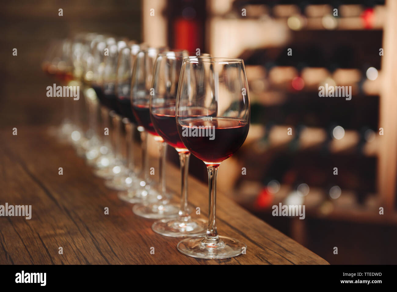 Many glasses of different wine in a row on bar counter Stock Photo - Alamy