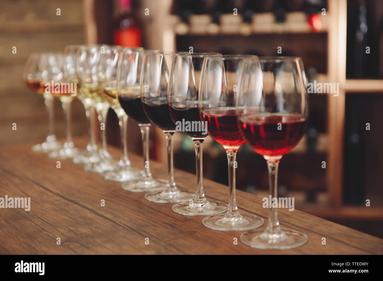 Many glasses of different wine in a row on bar counter Stock Photo - Alamy