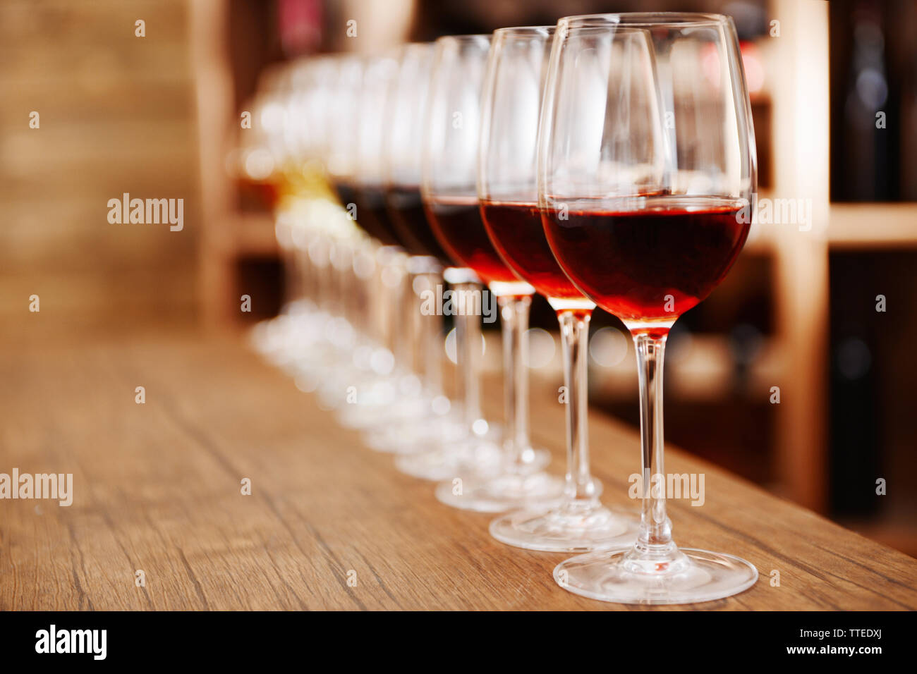 Many glasses of different wine in a row on bar counter Stock Photo - Alamy