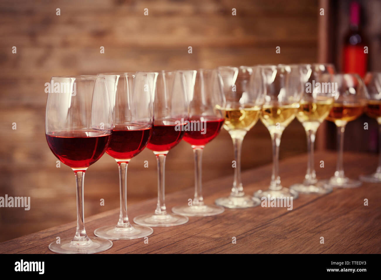 Many glasses of different wine in a row on bar counter Stock Photo - Alamy