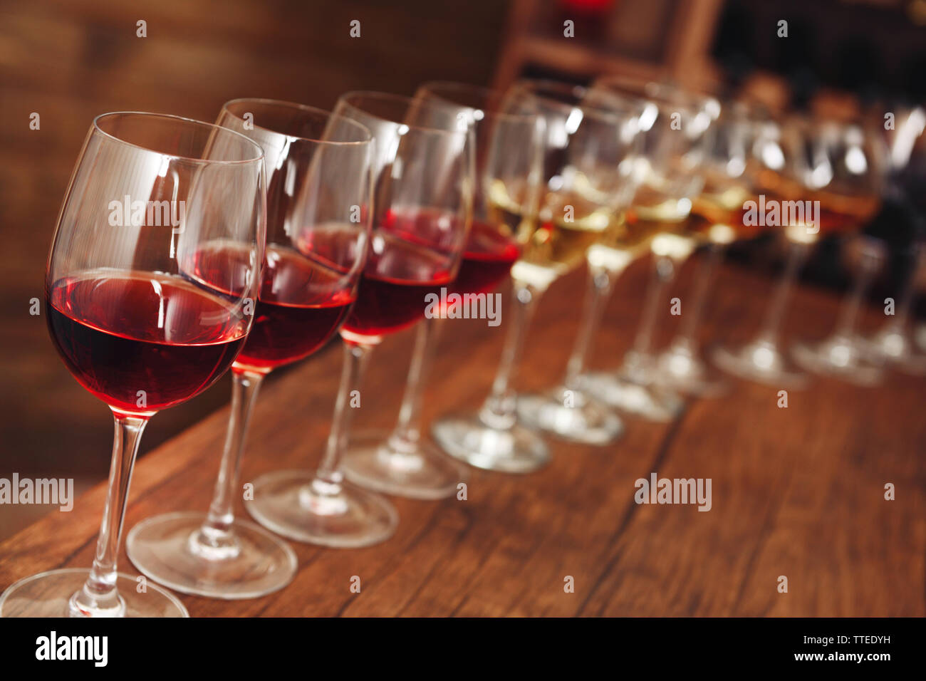 Many glasses of different wine in a row on bar counter Stock Photo - Alamy