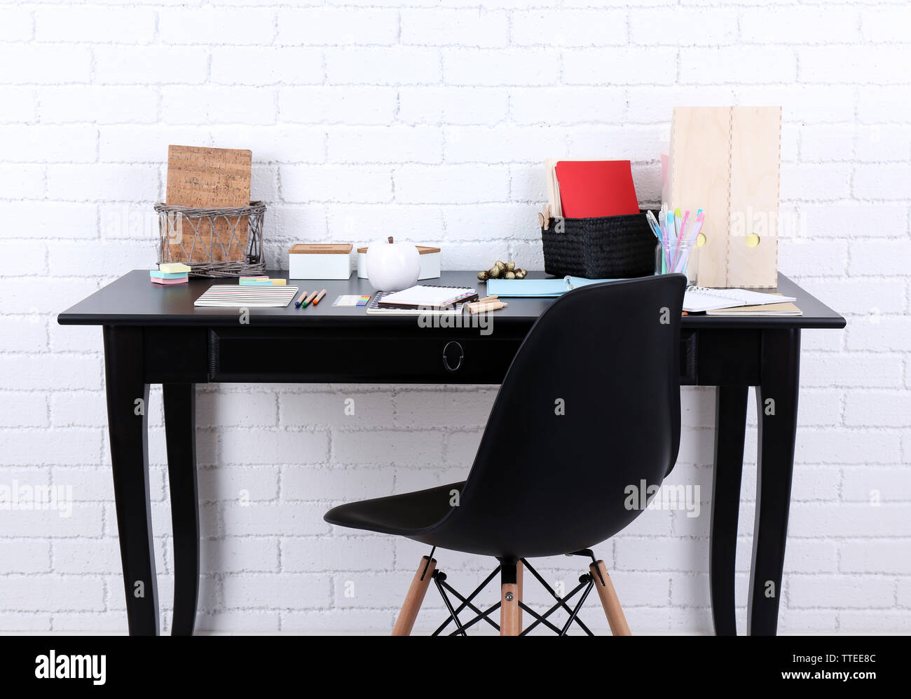 Workplace with table, stationery and chair in room interior Stock Photo ...