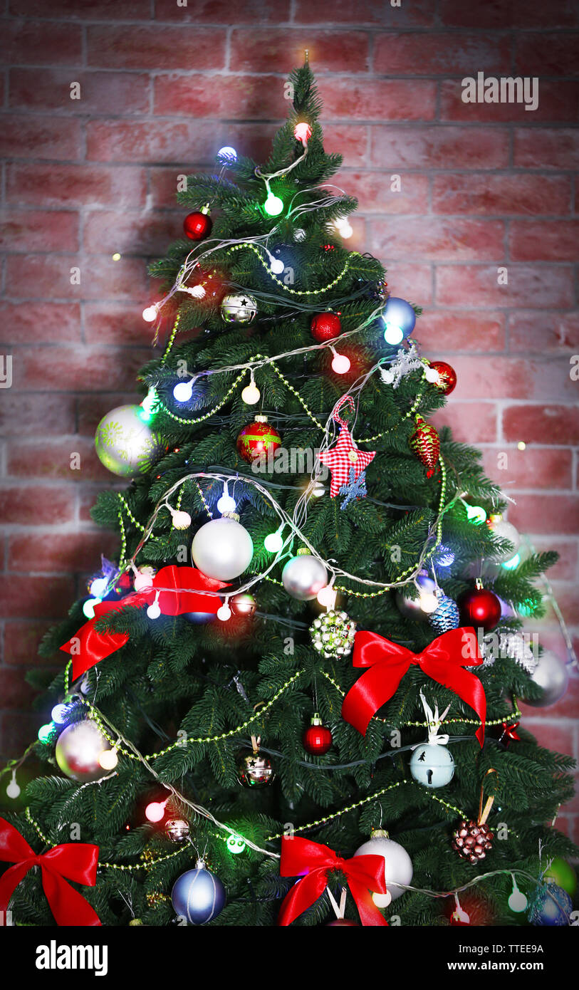 Christmas tree on a brick wall background Stock Photo - Alamy