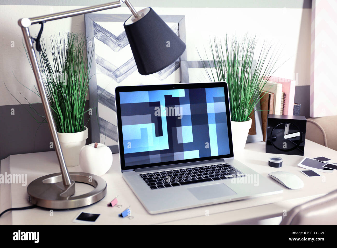 Workplace with table, lamp and laptop in living room Stock Photo - Alamy