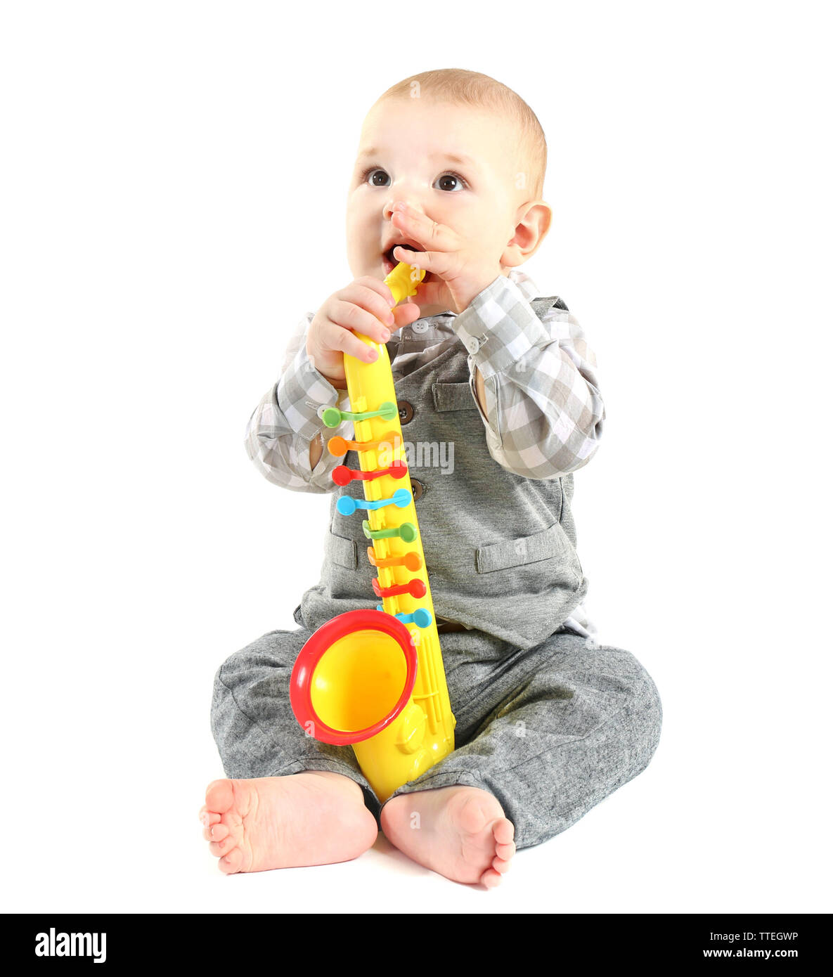 Adorable baby with plastic colourful saxophone isolated on white ...