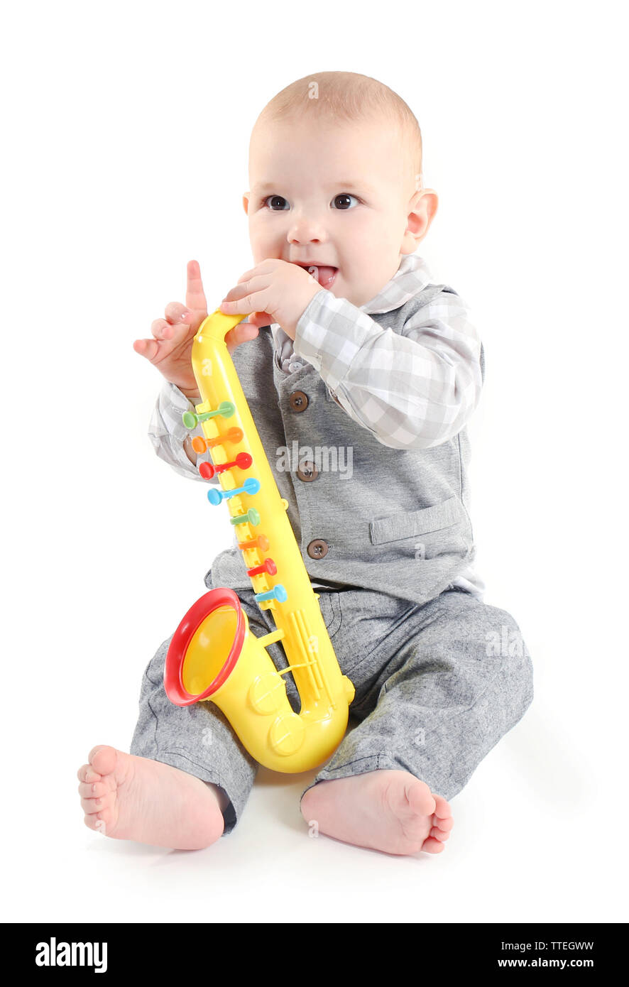 Adorable baby with plastic colourful saxophone isolated on white ...