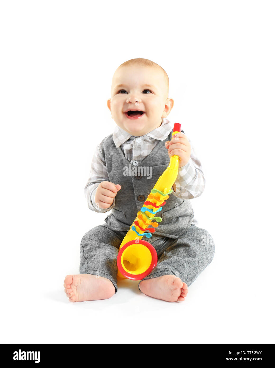 Adorable baby with plastic colourful saxophone isolated on white ...