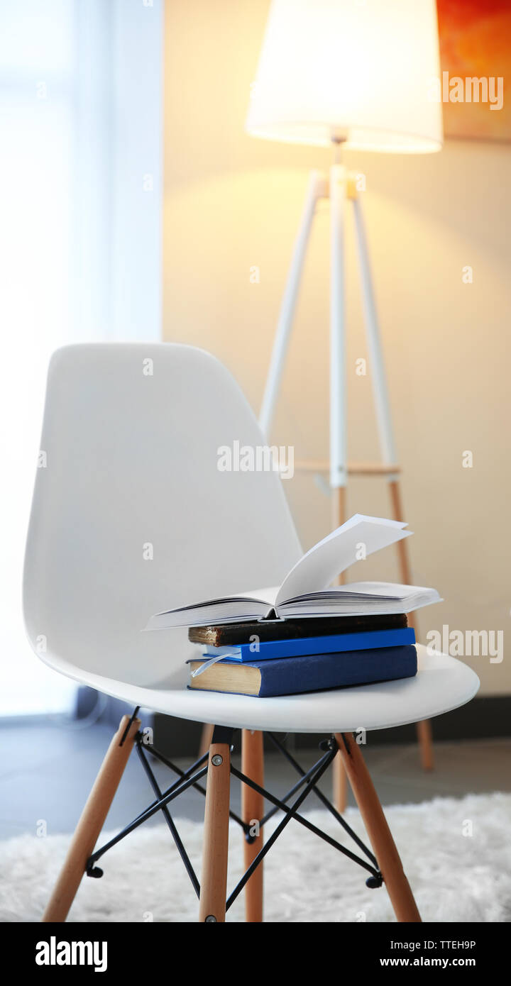 White chairs with books in a room Stock Photo - Alamy