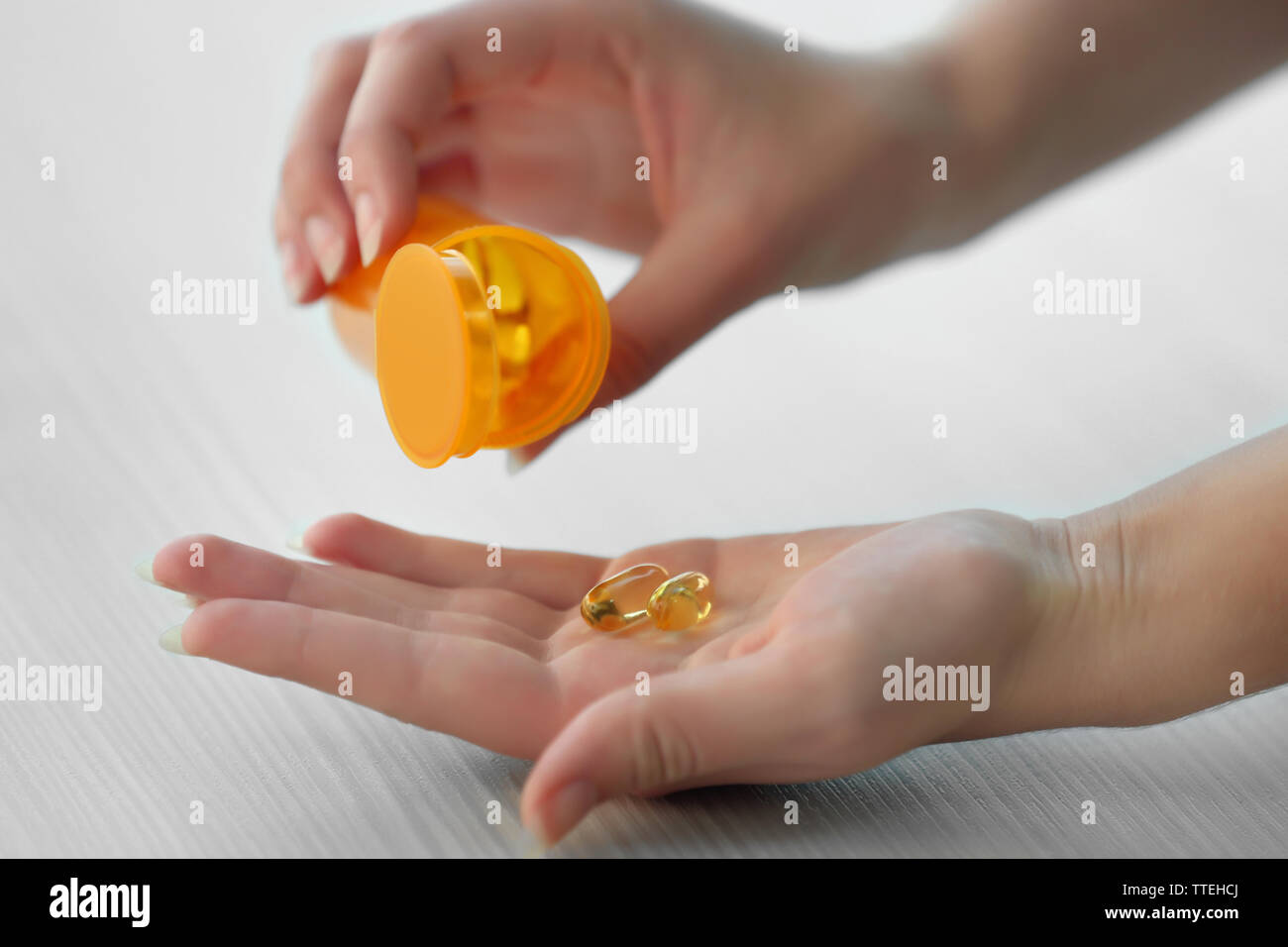 Woman spills yellow medical capsules to her hand, close up Stock Photo ...