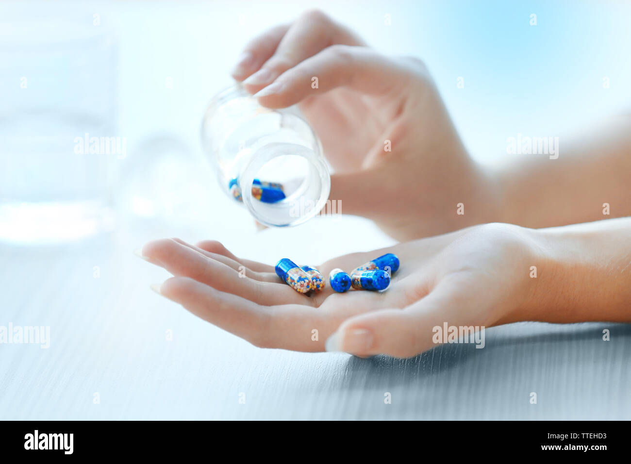 Woman spills blue medical capsules to her hand, close up Stock Photo ...