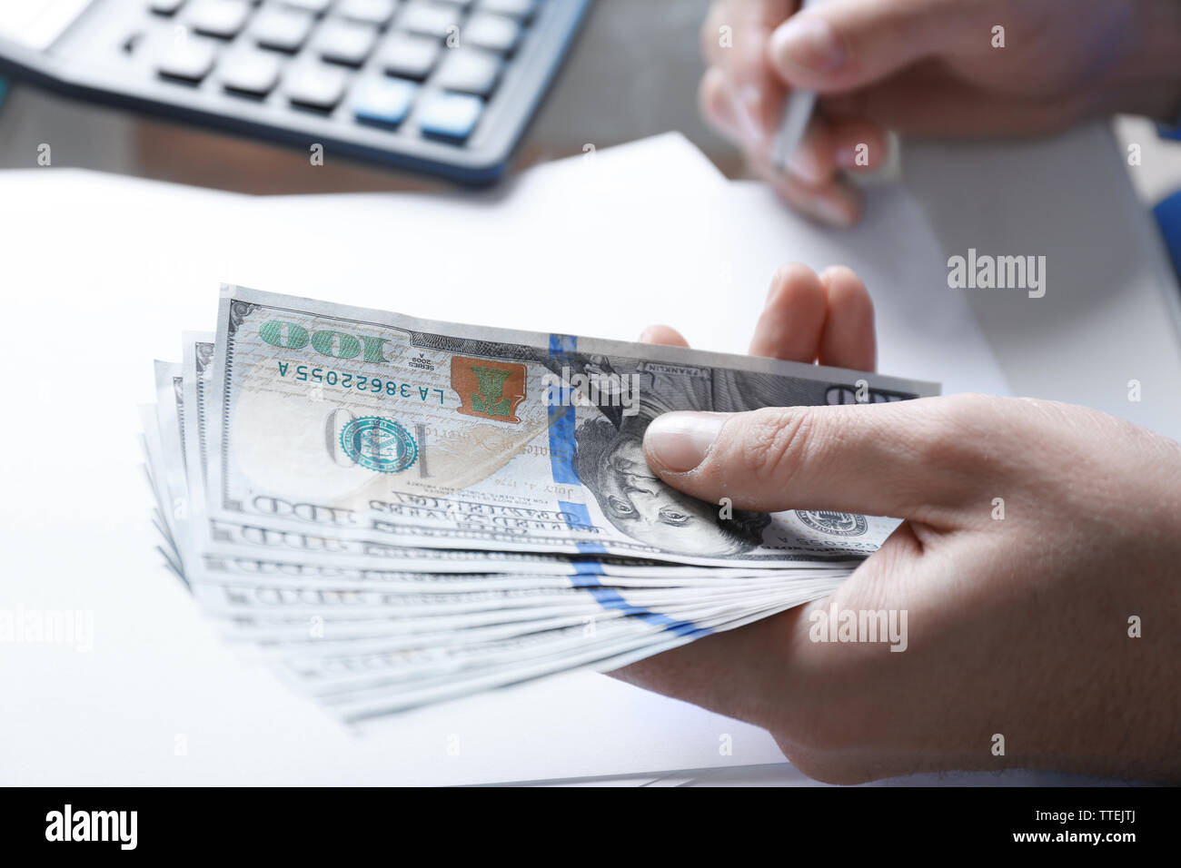 Hands counting money close hi-res stock photography and images - Alamy