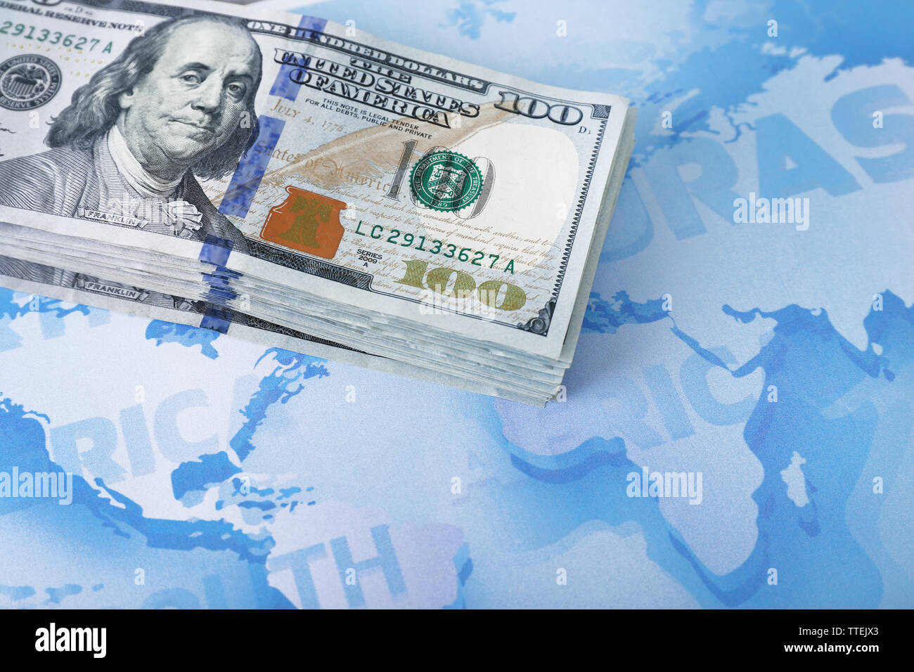 Cash on the world map background, close up Stock Photo - Alamy
